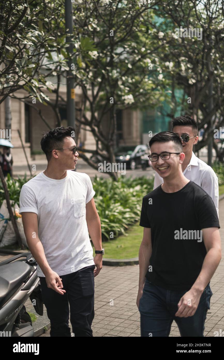 Portrait of Three asian young men in casual clothing walking on the ...
