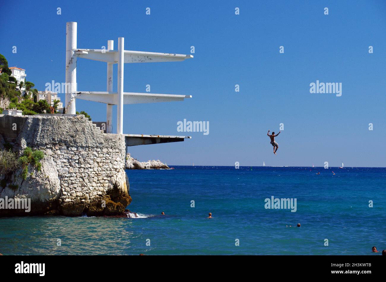 FRANCE. ALPES MARITIMES (06) NICE. A SWIMMER JUMPS FROM A DIVING BOARD ...