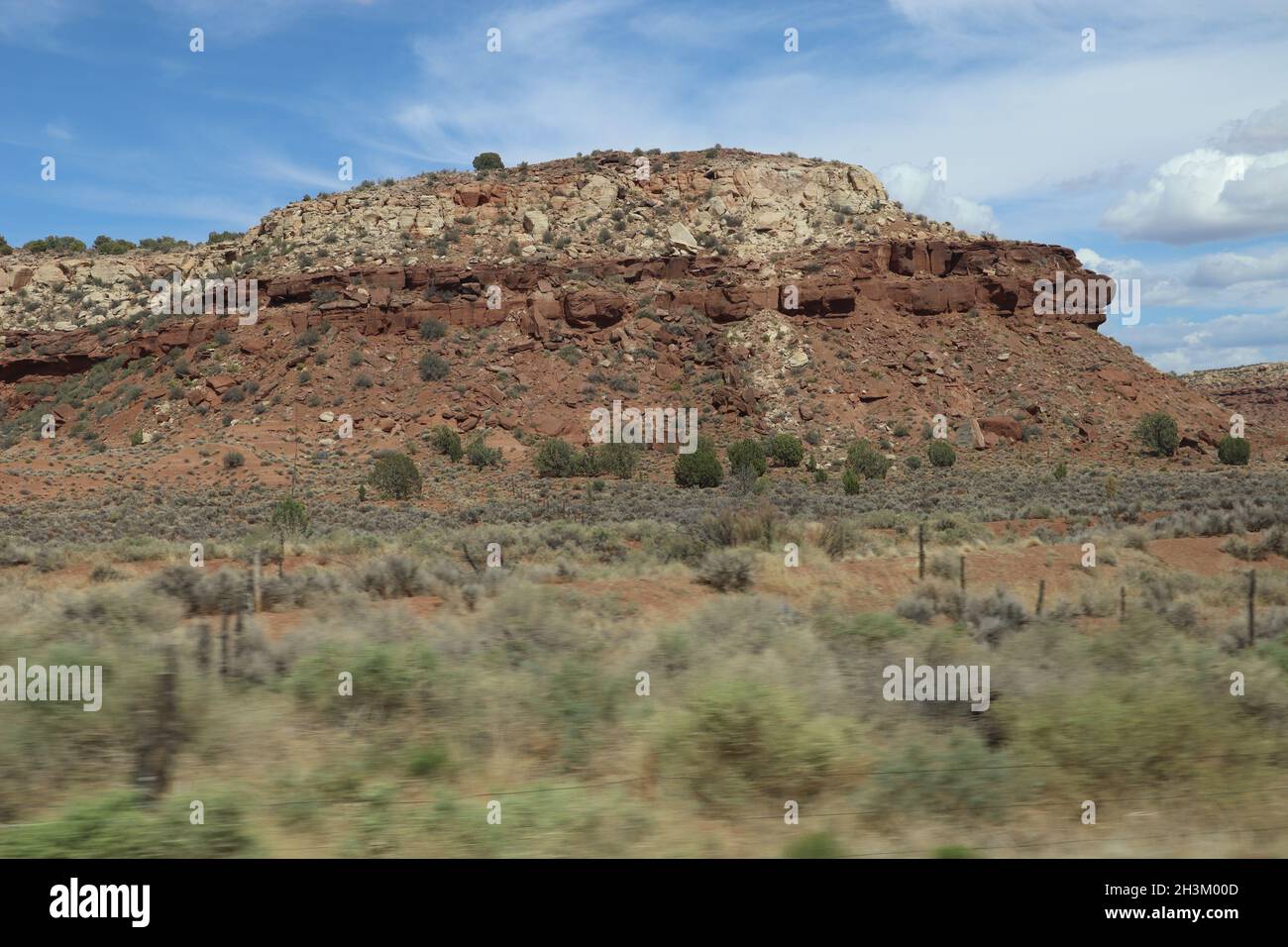 Mesa among rugged layered red rock dramatic desert landscape at the ...