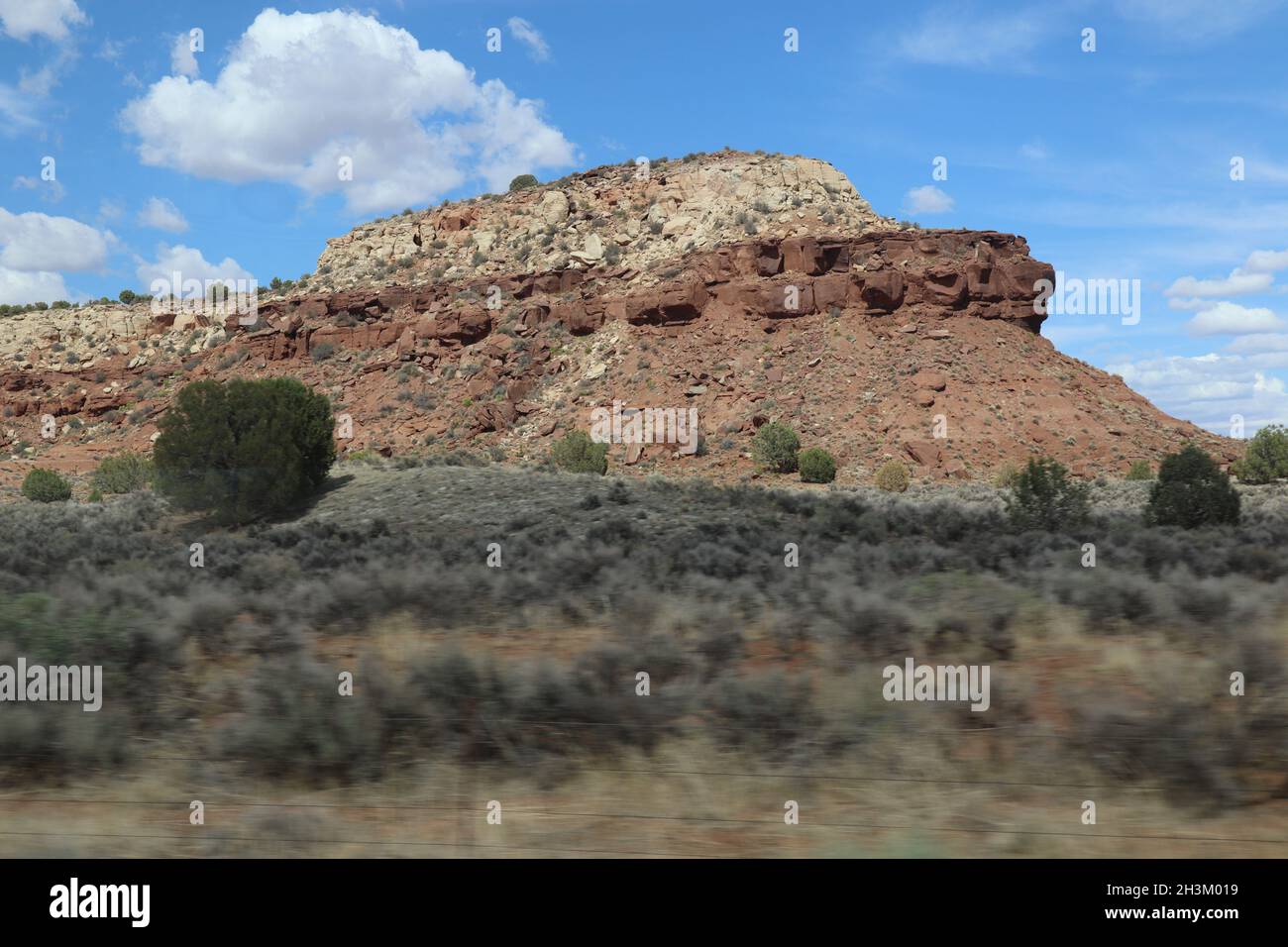 Mesa among rugged layered red rock dramatic desert landscape at the ...