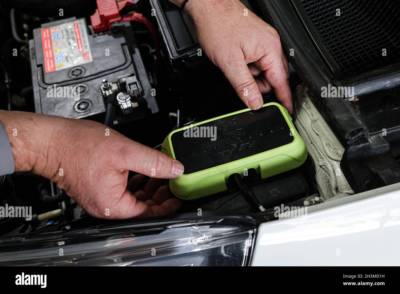 A garage owner installs a FlexFuel kit for switching to E-85 fuel ...