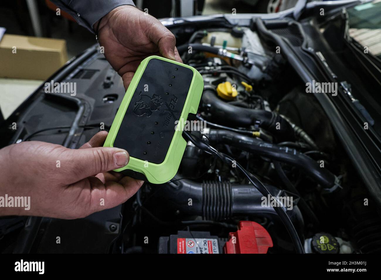 A garage owner installs a FlexFuel kit for switching to E-85 fuel ...