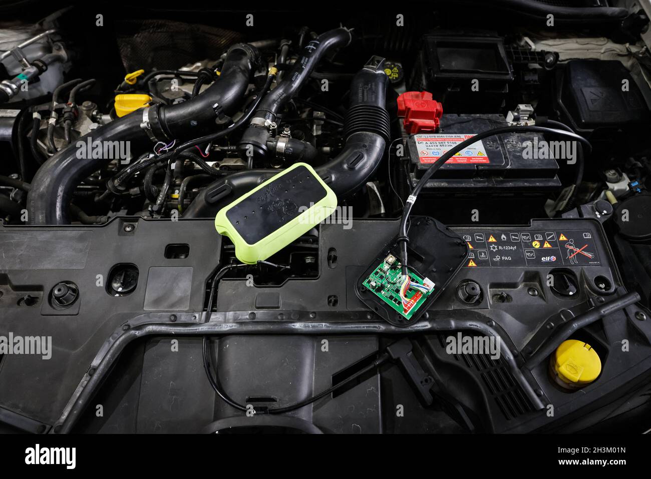 A garage owner installs a FlexFuel kit for switching to E-85 fuel ...