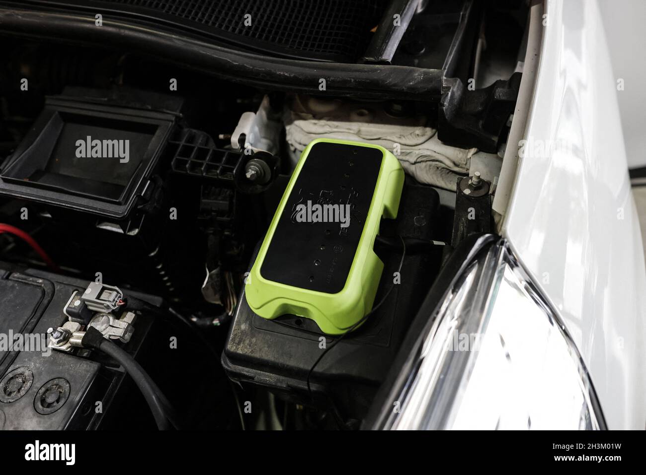 A garage owner installs a FlexFuel kit for switching to E-85 fuel ...