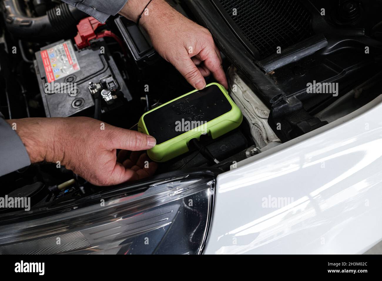 A garage owner installs a FlexFuel kit for switching to E-85 fuel ...