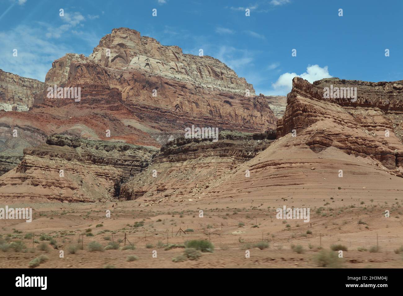 Mesa among rugged layered red rock dramatic desert landscape at the ...
