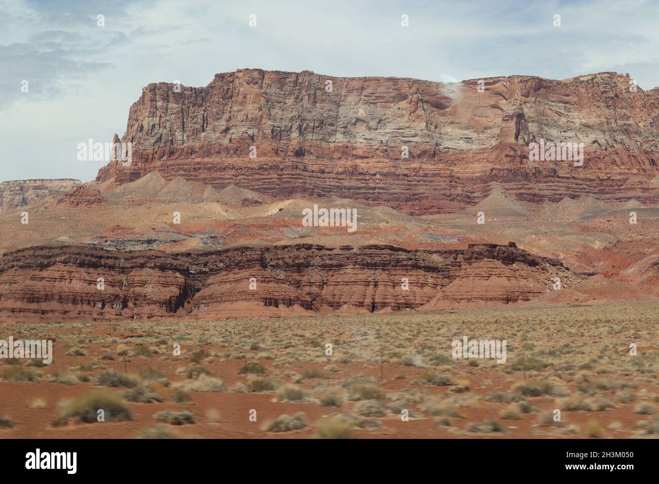 Mesa among rugged layered red rock dramatic desert landscape at the ...