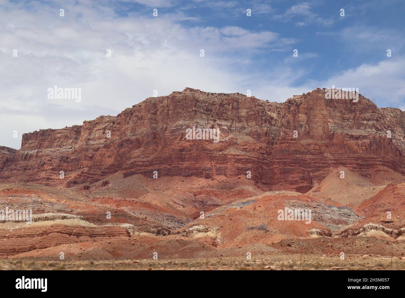 Mesa among rugged layered red rock dramatic desert landscape at the ...