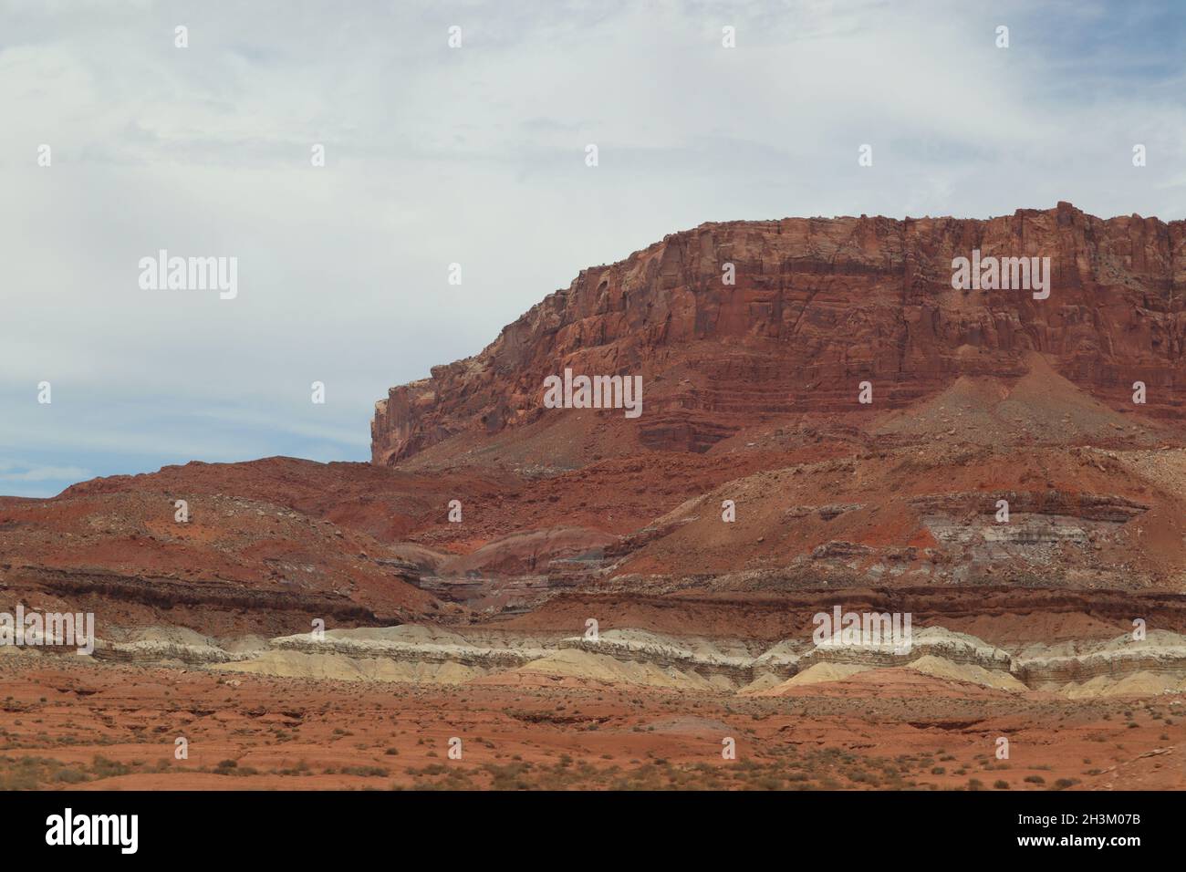 Mesa among rugged layered red rock dramatic desert landscape at the ...