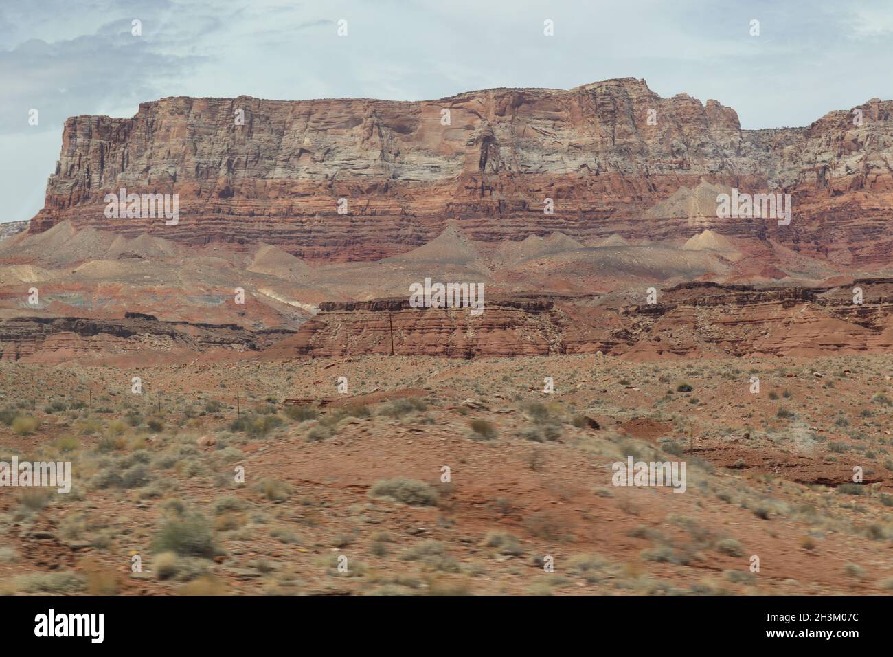 Mesa among rugged layered red rock dramatic desert landscape at the ...