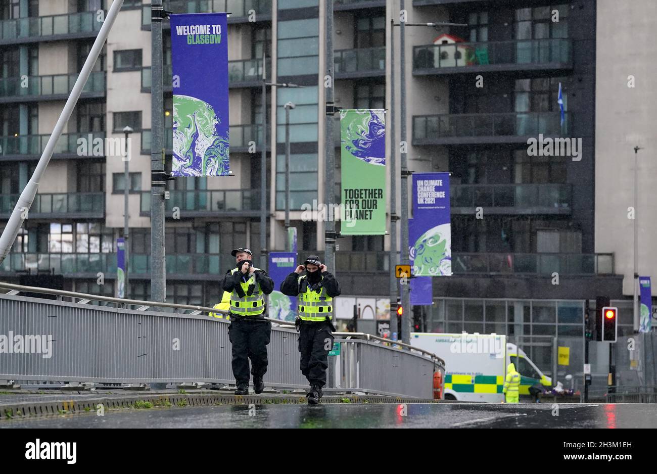 Police officers walk nearby streets to the Scottish Event Campus in ...