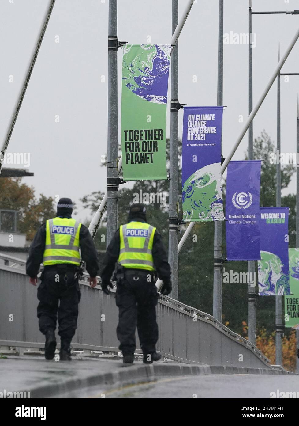 Police officers walk nearby streets to the Scottish Event Campus in ...