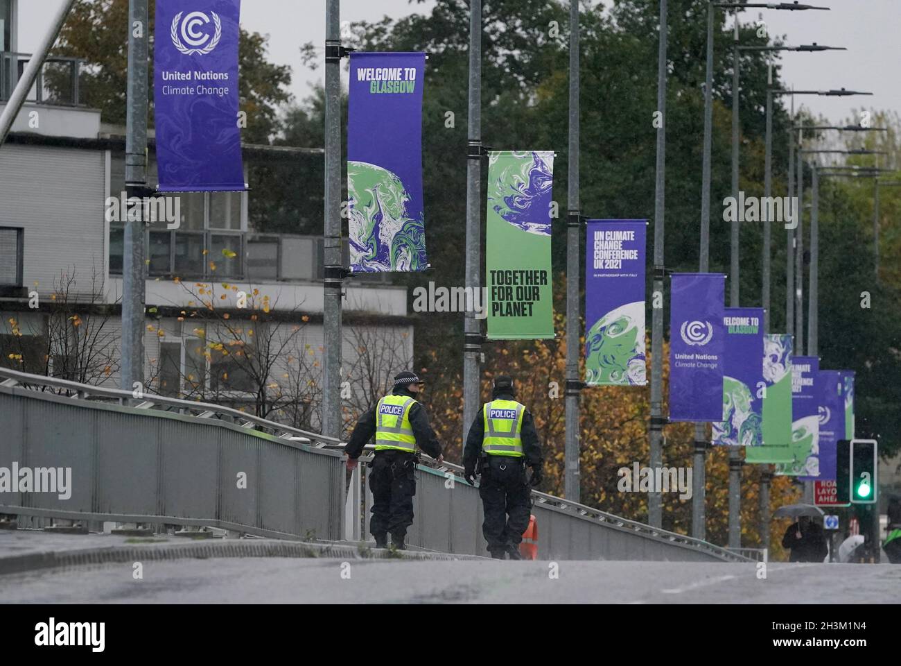 Police officers walk nearby streets to the Scottish Event Campus in ...