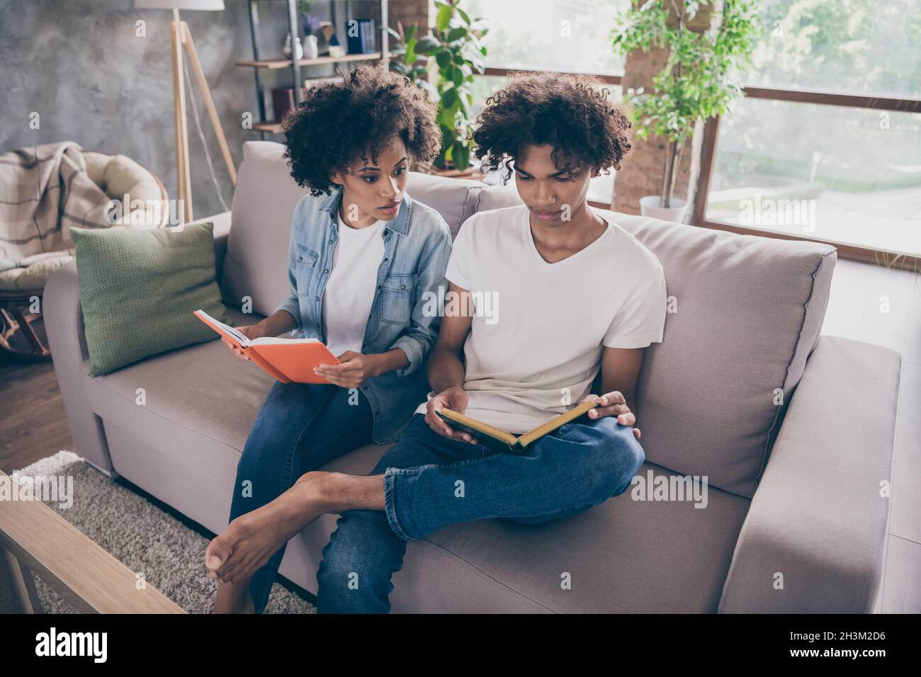Photo of two friends hold textbook read lesson study homework wear ...