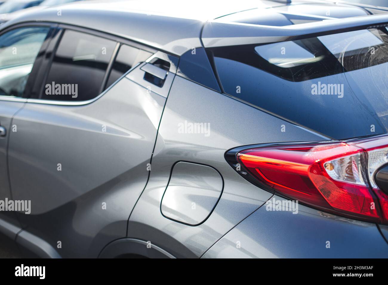 Side view of turning luxury grey car Stock Photo - Alamy
