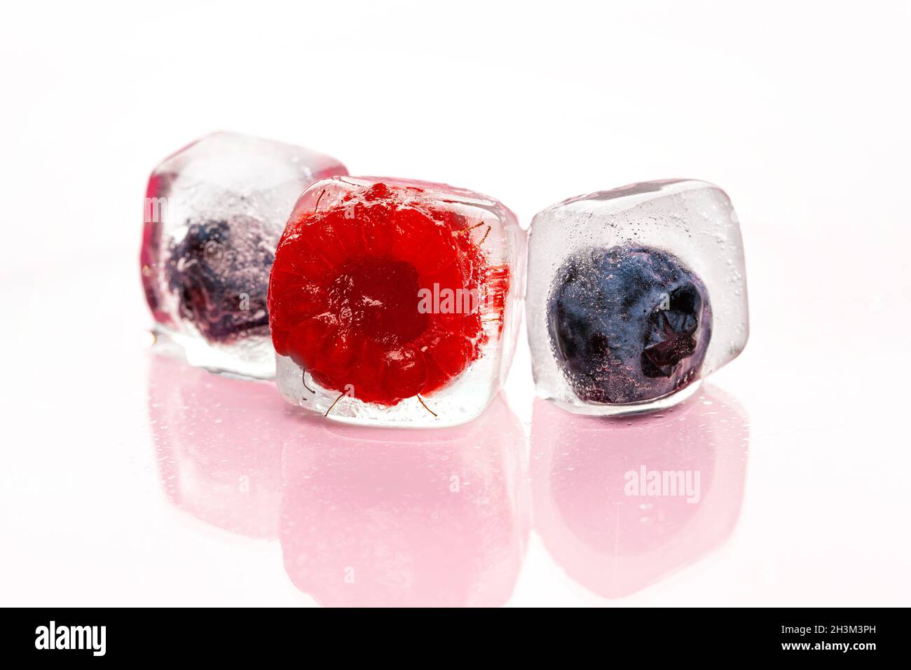 Berry ice cubes for decorating beverages close up Stock Photo - Alamy