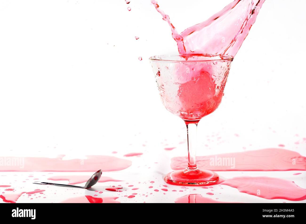 Red alcohol cocktail drink splash on white background Stock Photo - Alamy