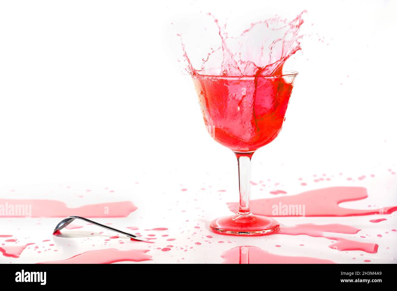 Red alcohol cocktail drink splash on white background Stock Photo - Alamy