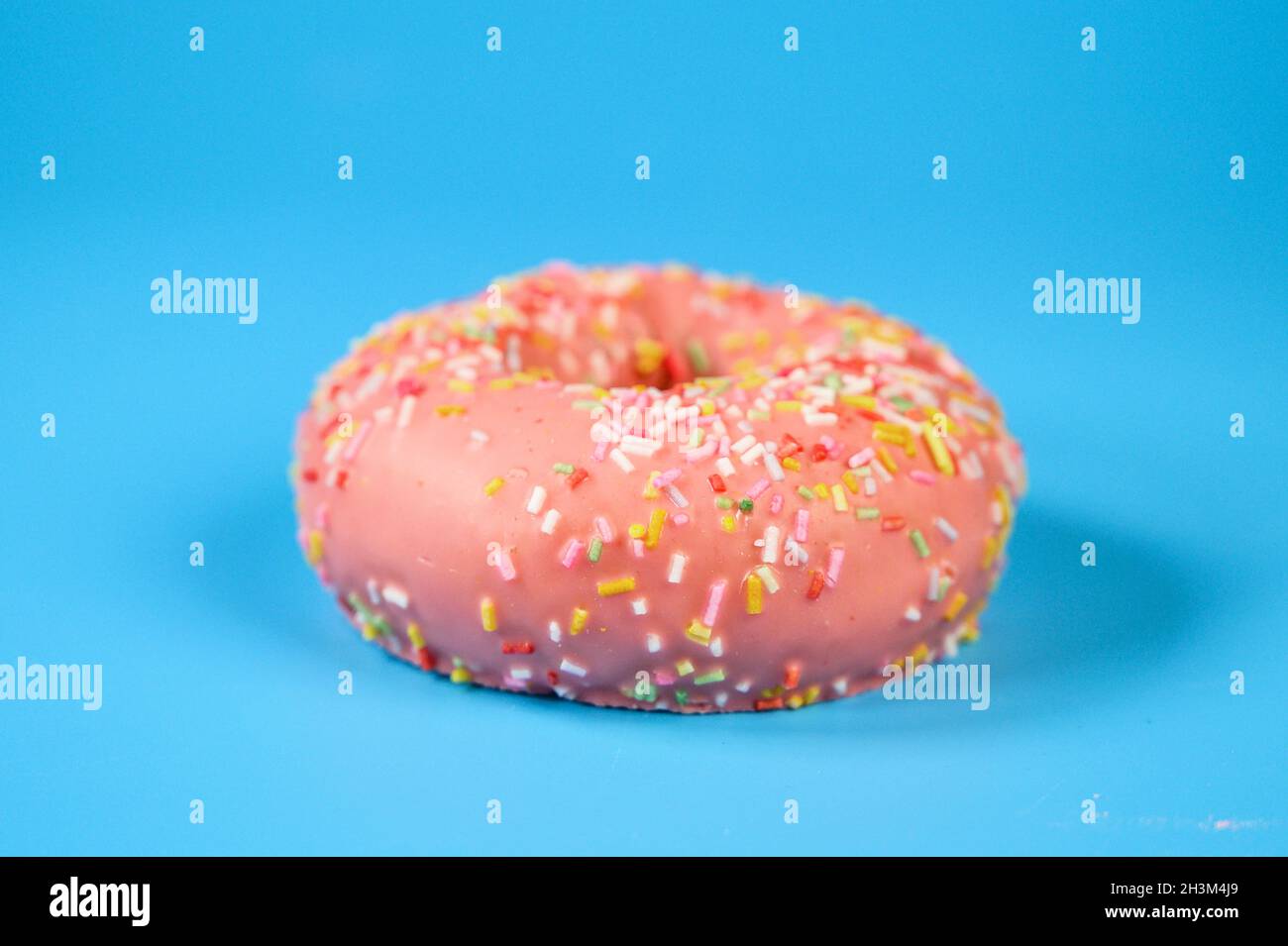 Pink iced donut on blue background. Sweet dessert top view Stock Photo ...