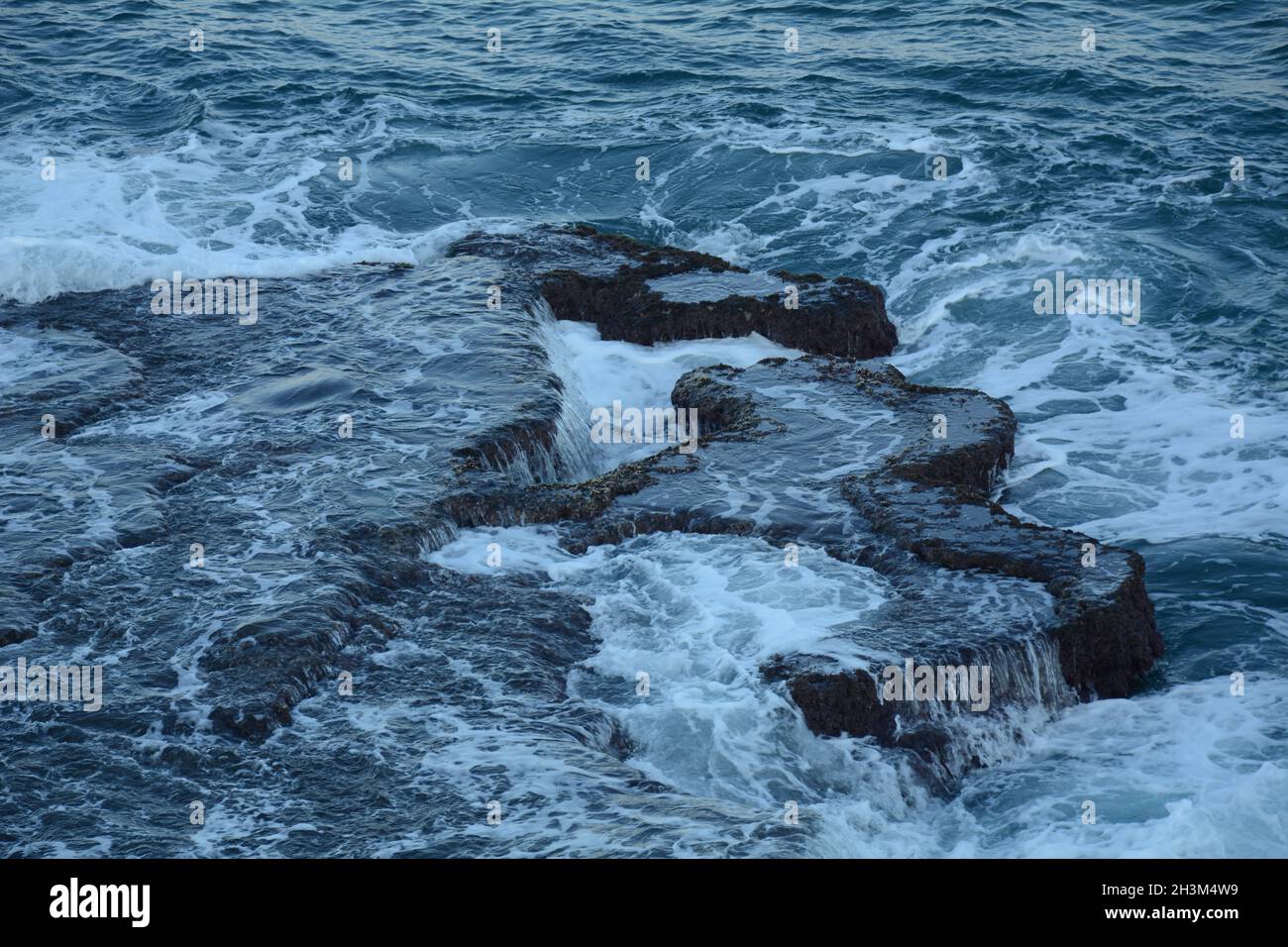 Sea Waves Crashing on the Rocks with White Foam. Swirling frothy foamy ...
