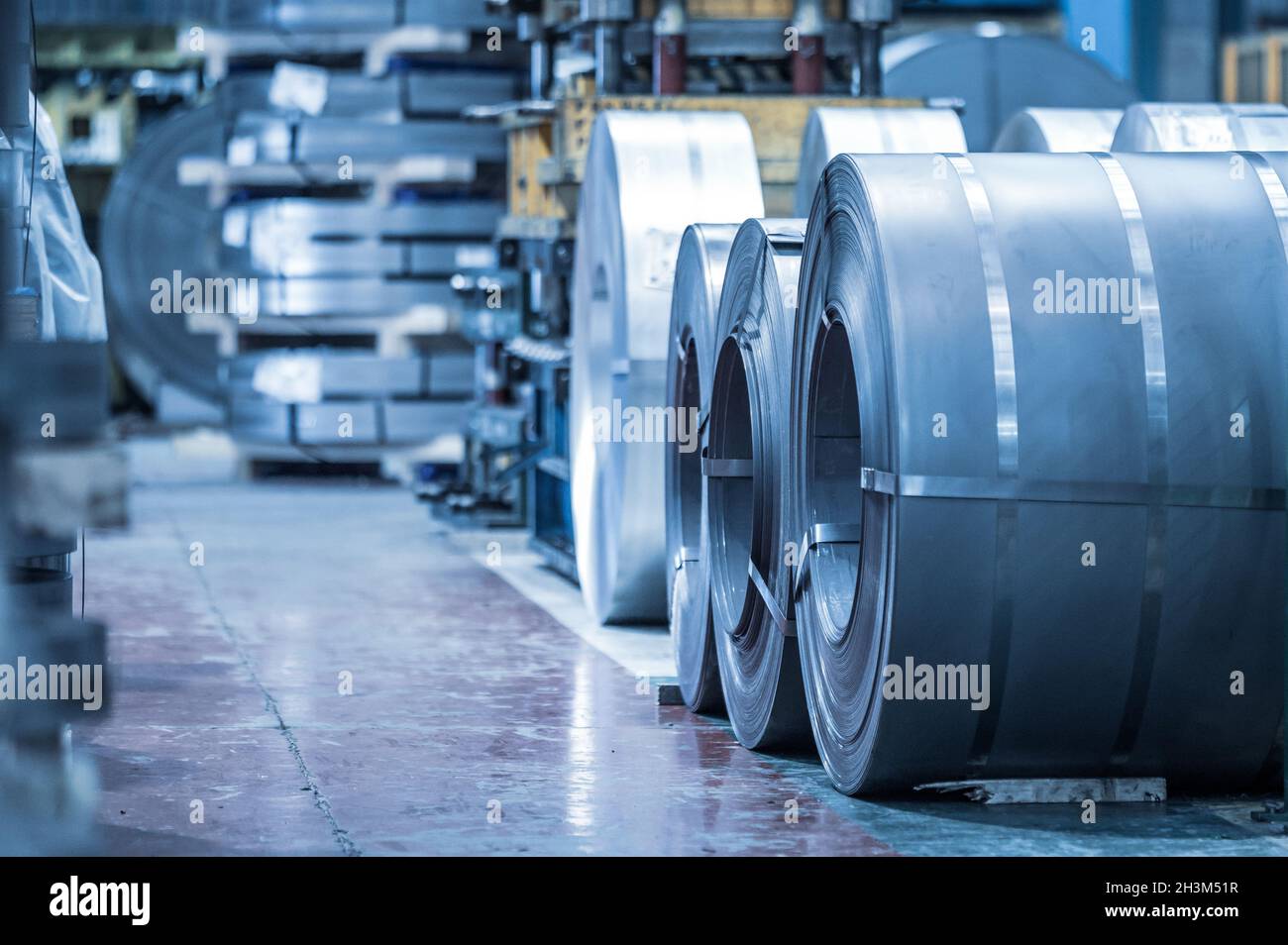 Industrial background. Big size steel coil stored inside industrial ...