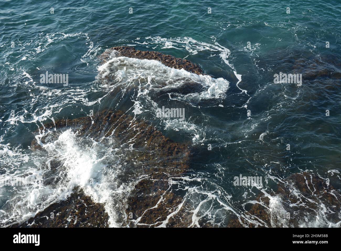Sea Waves Crashing on the Rocks with White Foam. Swirling frothy foamy ...