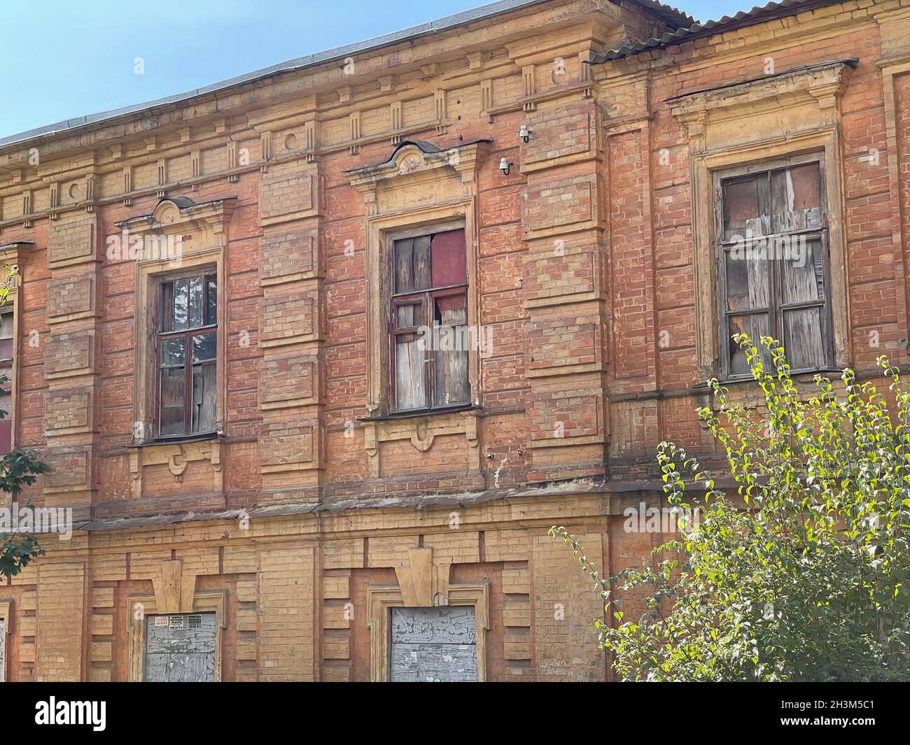 Facade of architectural abandoned building. Neglected historic house in ...