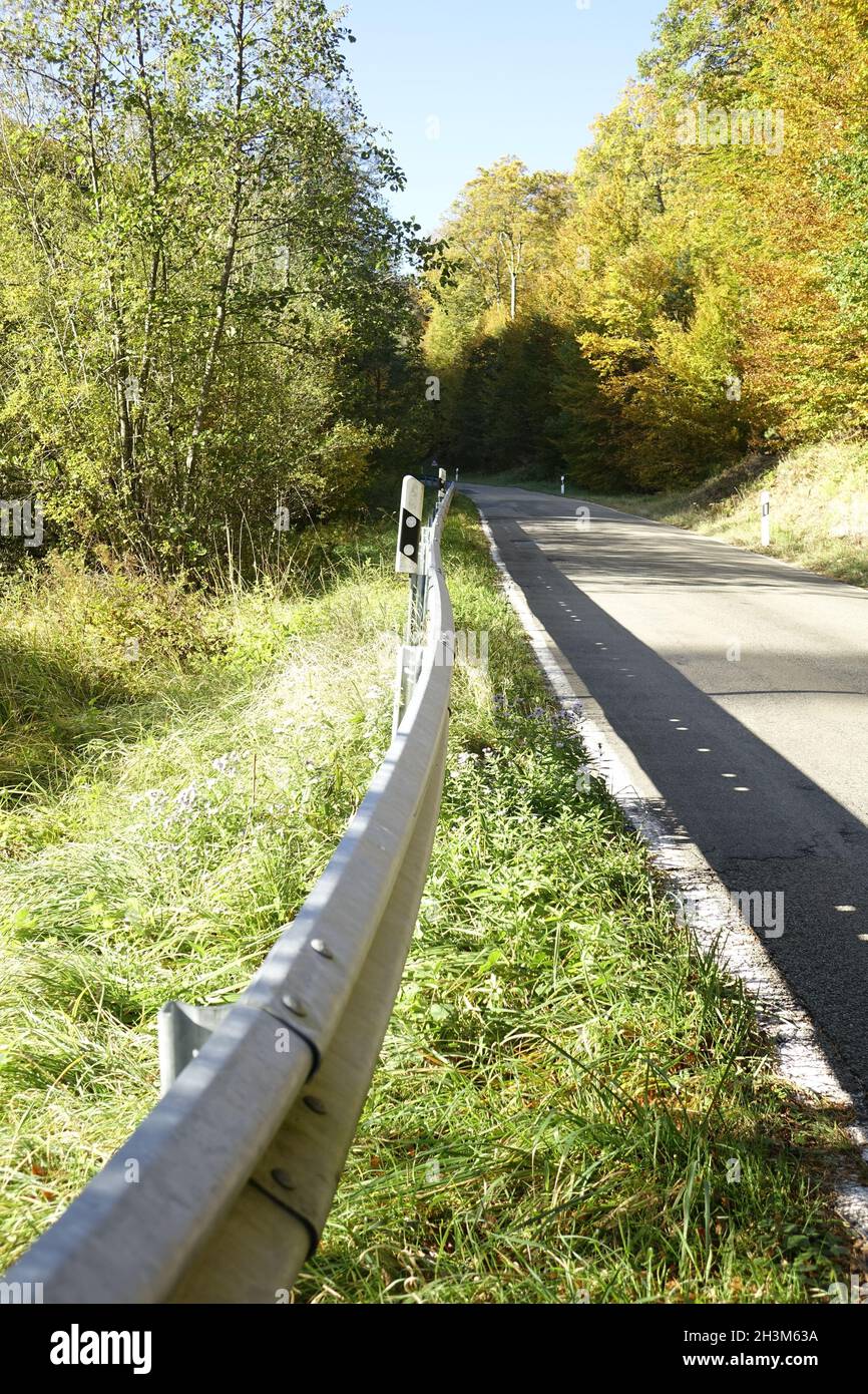 Small Germany highway with crash barrier and black and white reflector ...