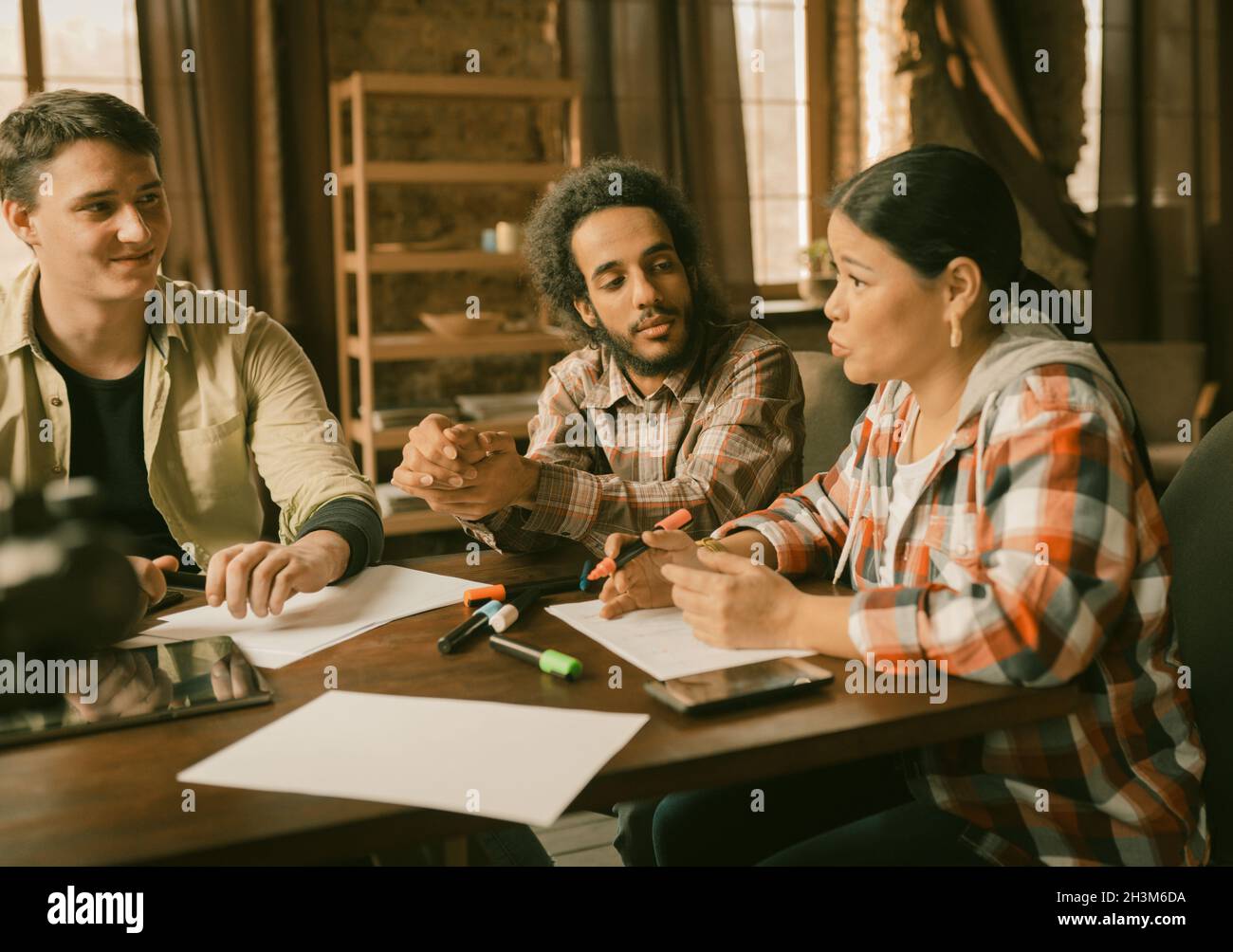 Group Of Young People working together In Office Stock Photo - Alamy