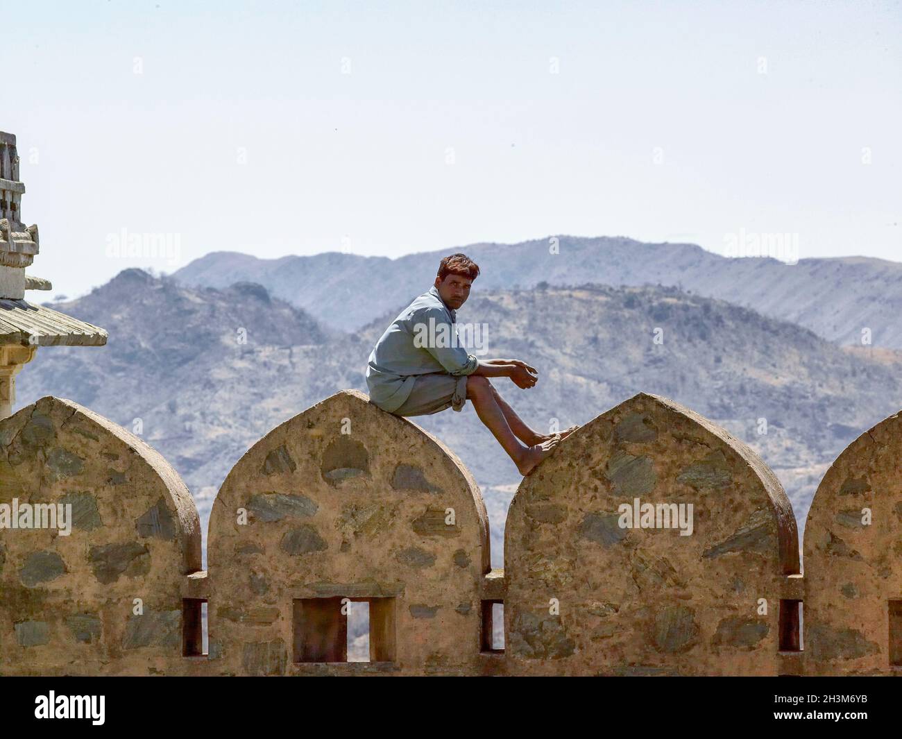 Man sitting on the battlements of Kumbhalgarth hilltop fort, In the ...