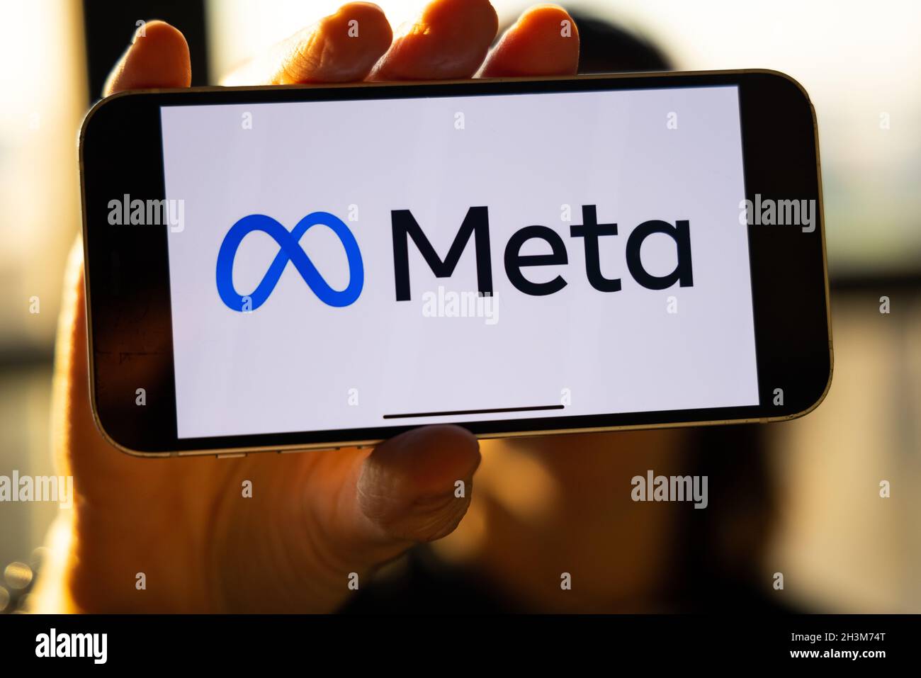 Meta logo on the iPhone. Woman holding smartphone with new facebook ...