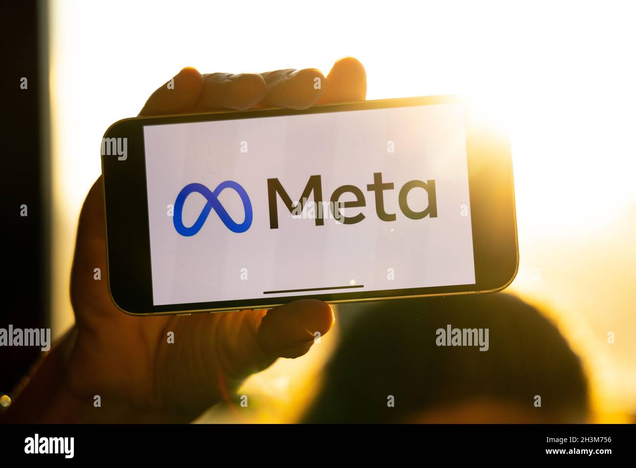 Meta logo on the iPhone. Woman holding smartphone with new facebook ...