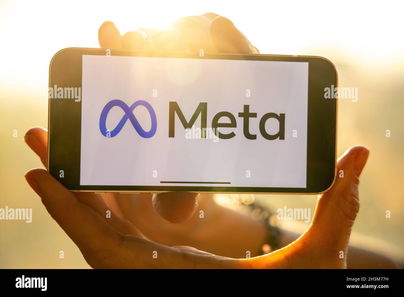 Meta logo on the iPhone. Woman holding smartphone with new facebook ...
