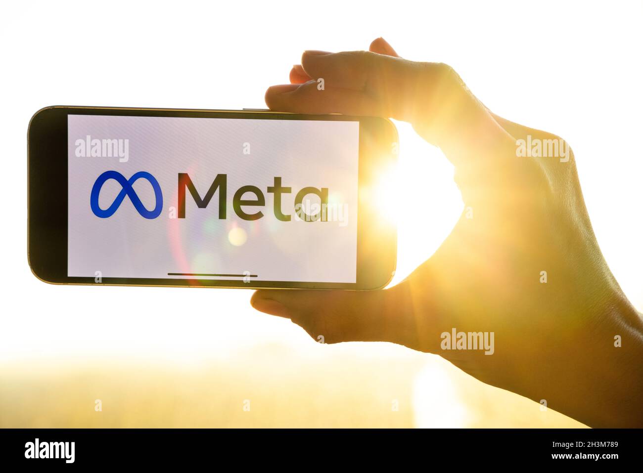 Meta logo on the iPhone. Woman holding smartphone with new facebook ...
