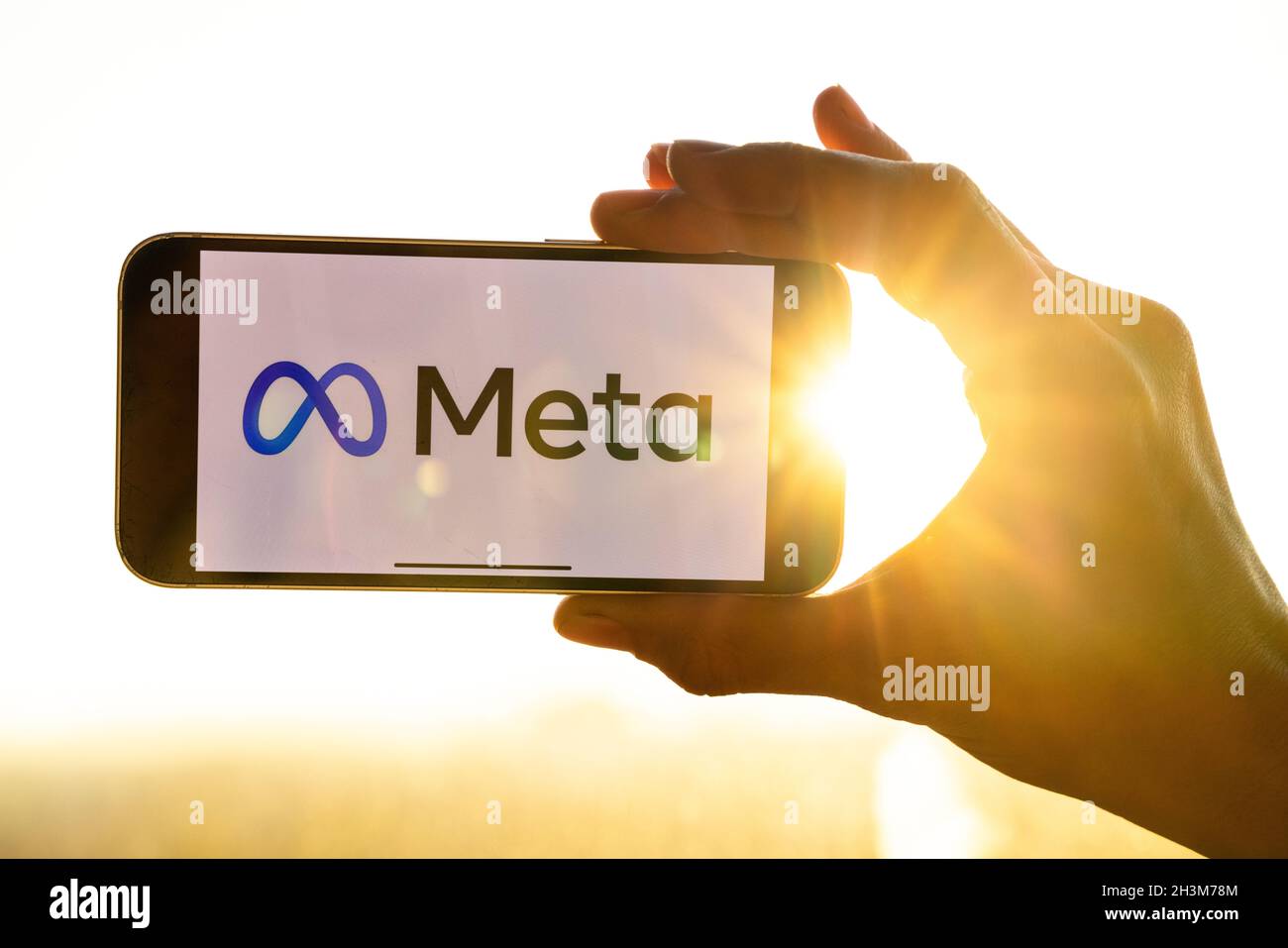 Meta logo on the iPhone. Woman holding smartphone with new facebook ...