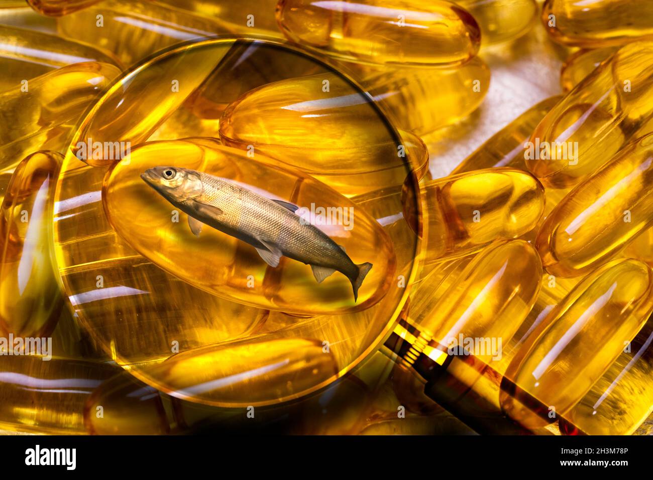 Magnifying glass zooms in on the omega3 capsule with a live fish inside ...