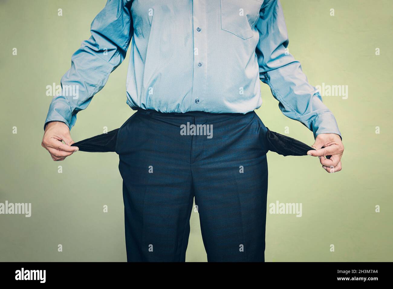 businessman standing on the green background and showing his empty ...