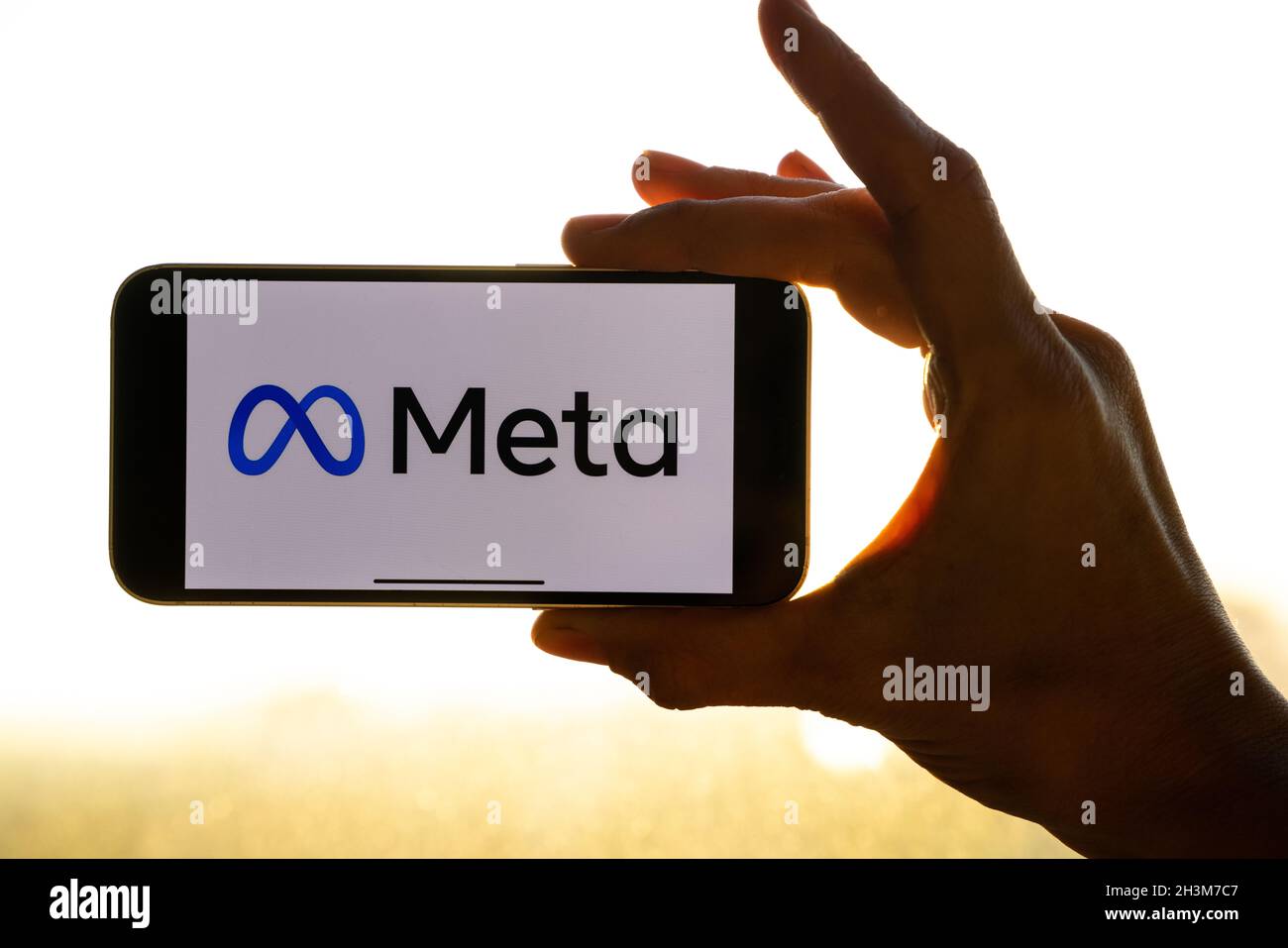 Meta logo on the iPhone. Woman holding smartphone with new facebook ...