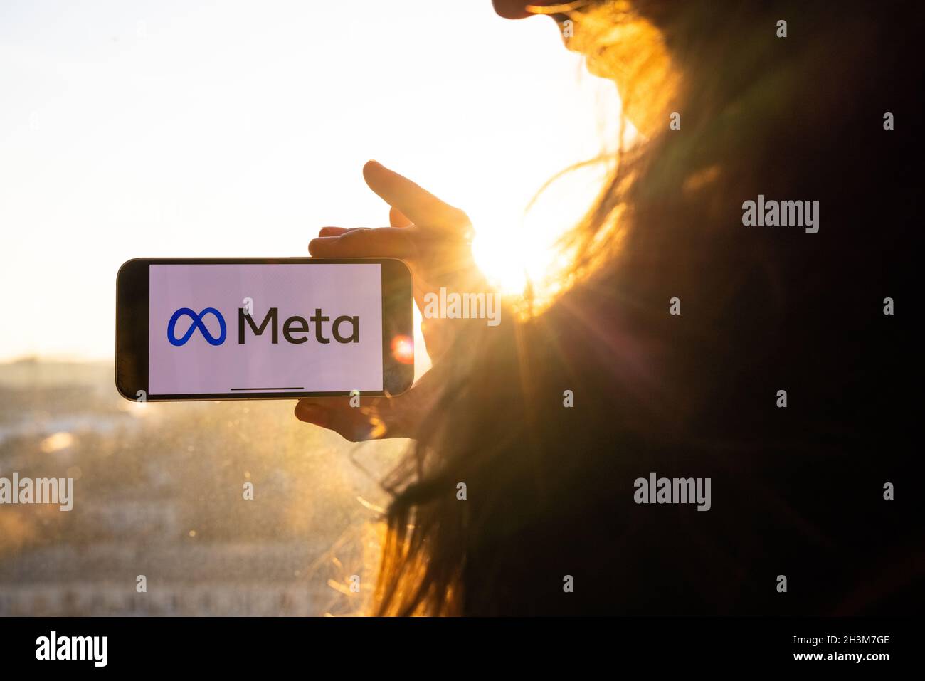 Meta logo on the iPhone. Woman holding smartphone with new facebook ...