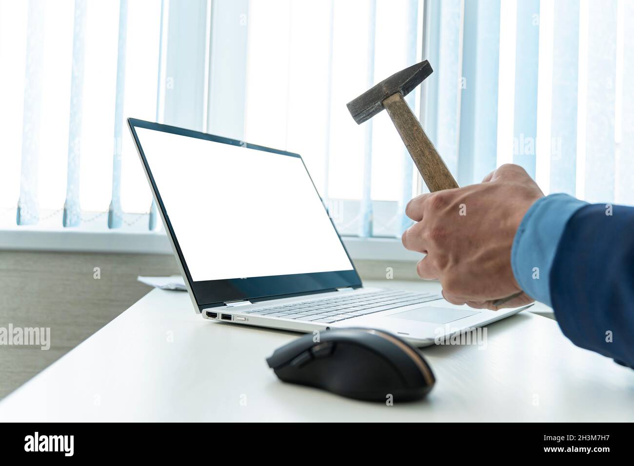 Person hitting a laptop screen with a hammer in frustration. empty ...