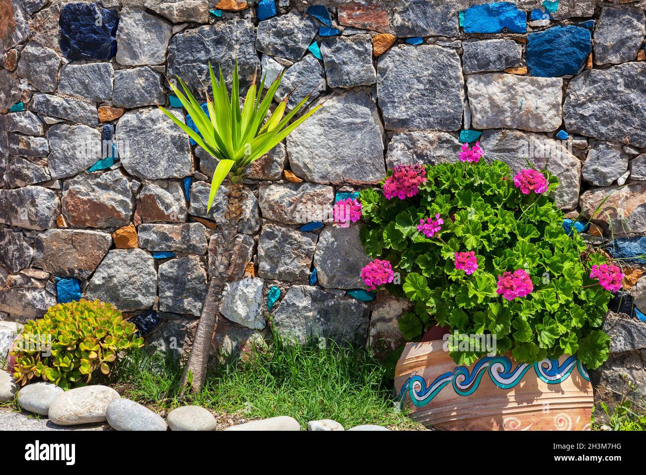 Stone wall with flowers Stock Photo - Alamy