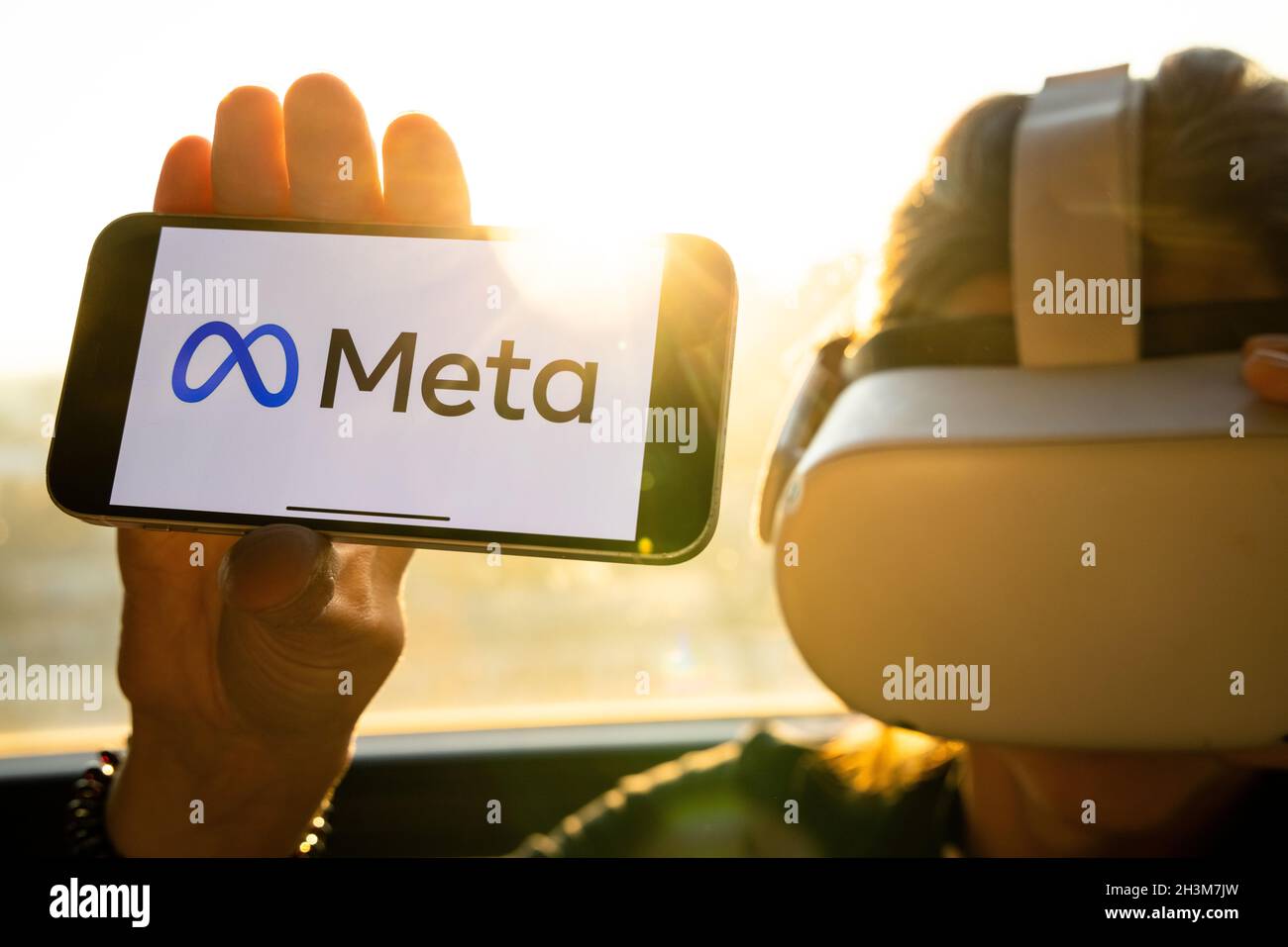 Meta logo on the iPhone, rebranding. Woman holding smartphone with new ...