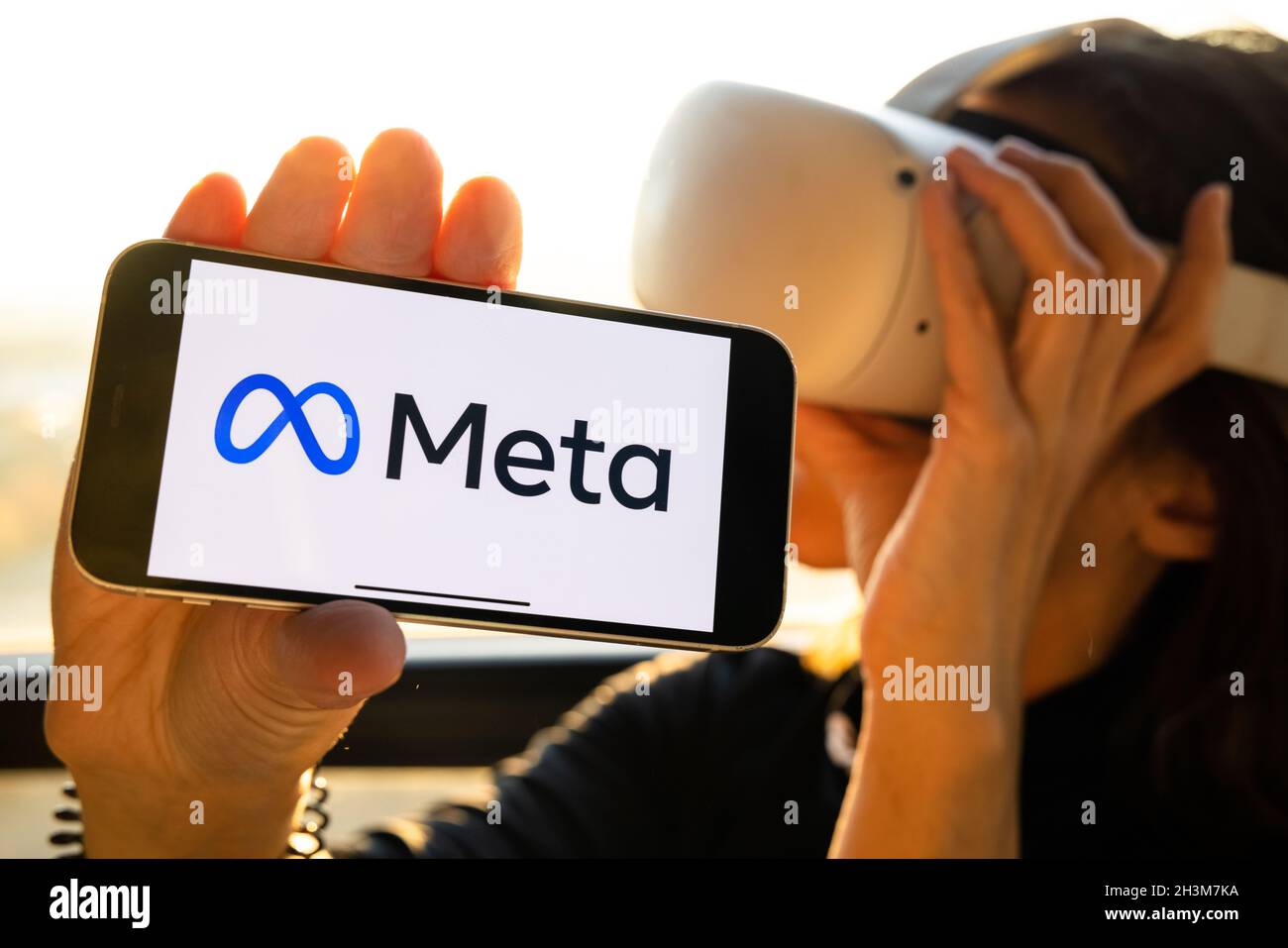 Meta logo on the iPhone, rebranding. Woman holding smartphone with new ...