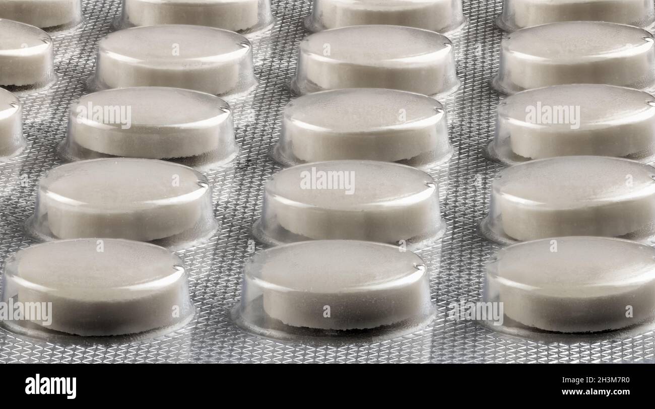 generic white medical tablets in silver foil blister Stock Photo - Alamy