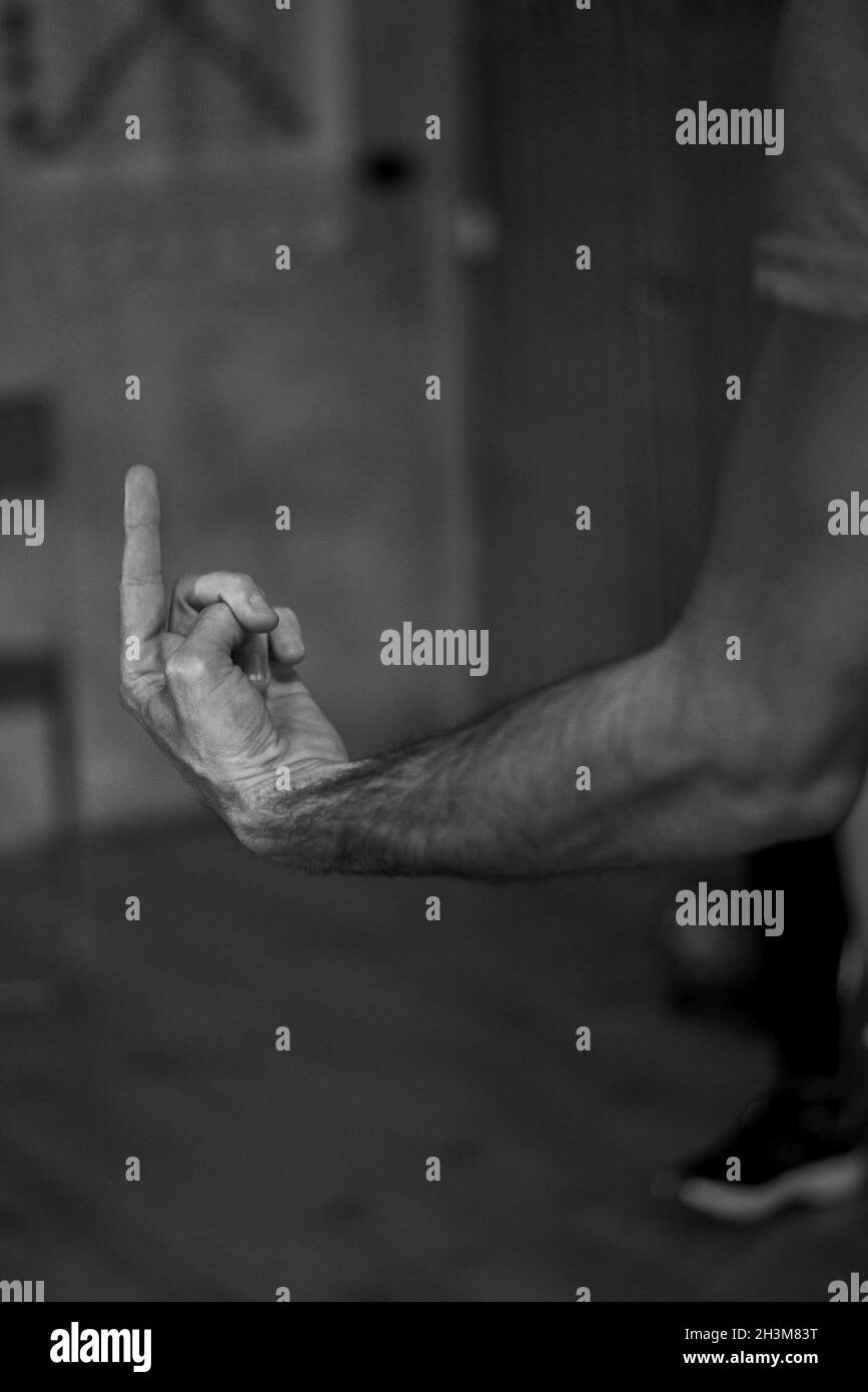 Vertical grayscale closeup of the man's hand showing the pointing ...