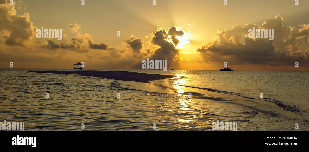 Beautiful tropical sunset over a sandbar in South Ari Atoll in the ...