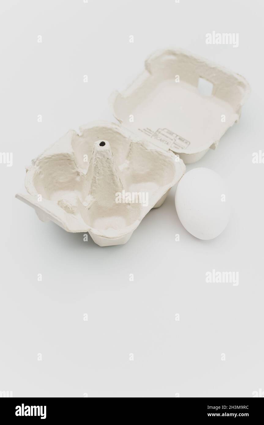 recycled cardboard egg box with one egg on a white background Stock ...