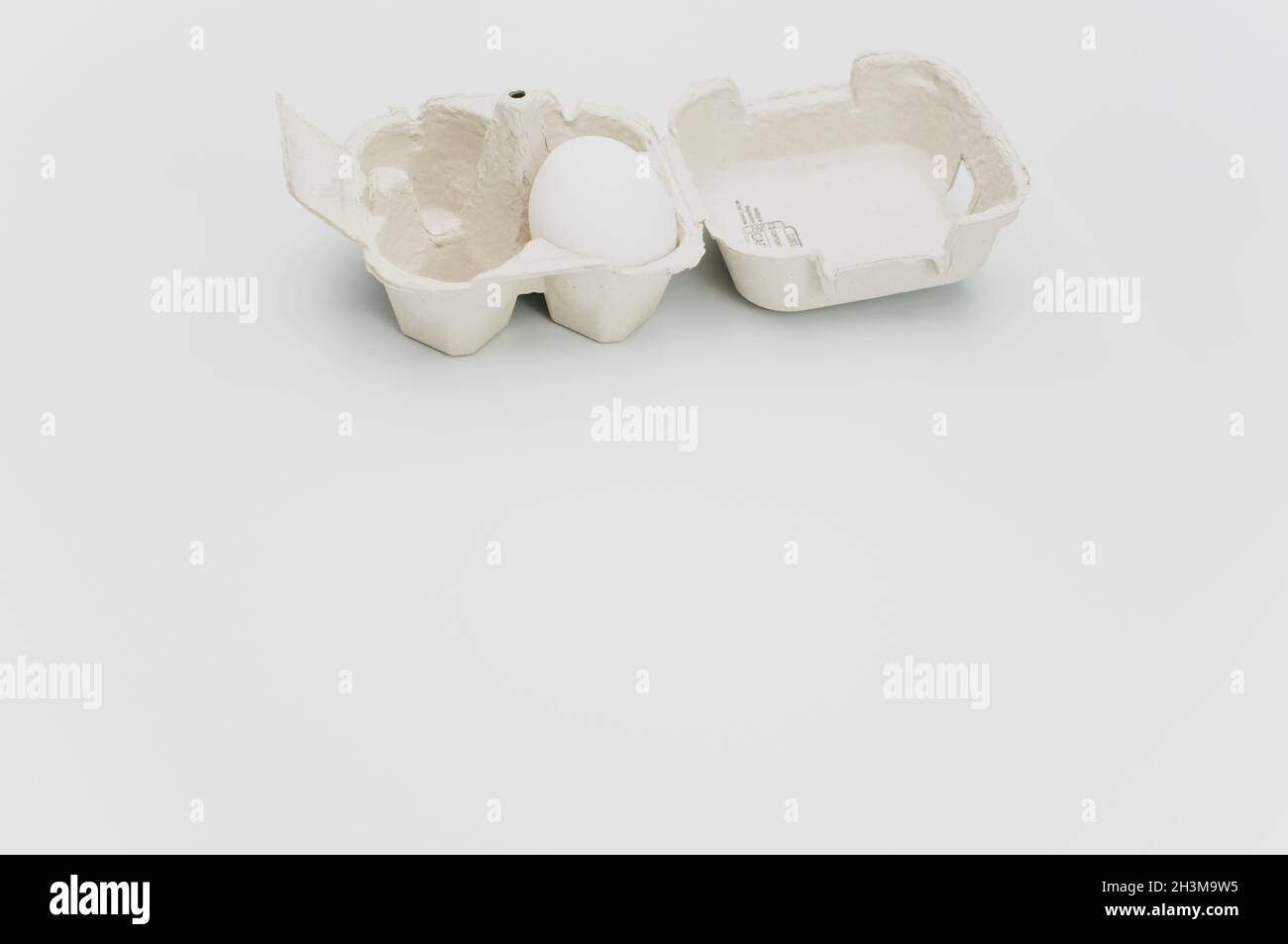 recycled cardboard egg box with one egg on a white background Stock ...