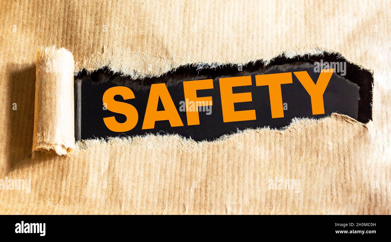 Brown torn cardboard with text label Safety. Safety concept Stock Photo ...