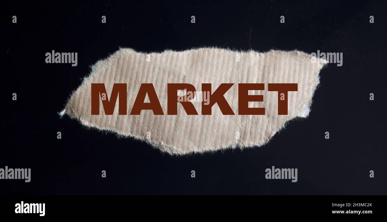 Market text on scrap of paper and black glass background Stock Photo ...
